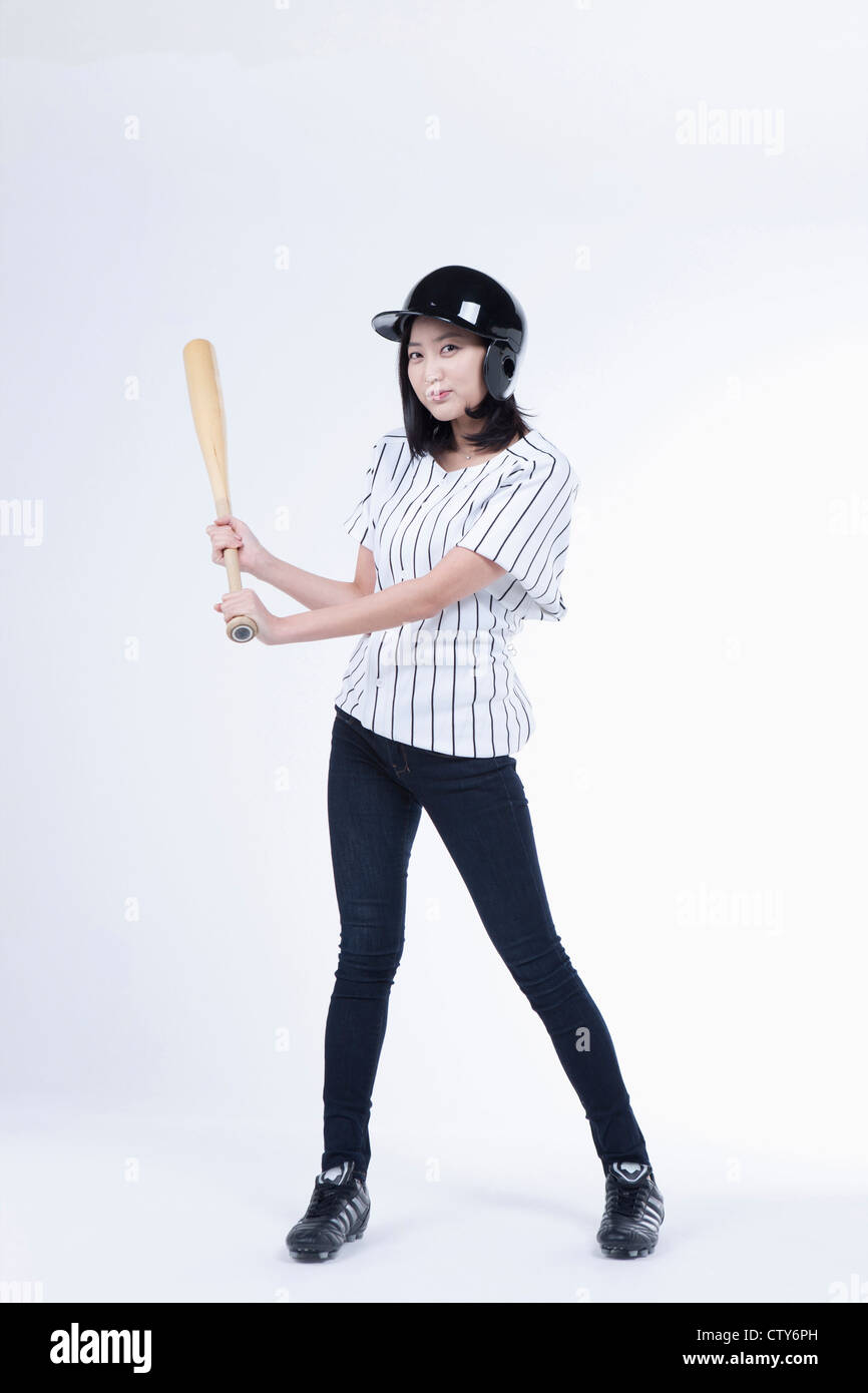 A female baseball player with a bat Stock Photo - Alamy
