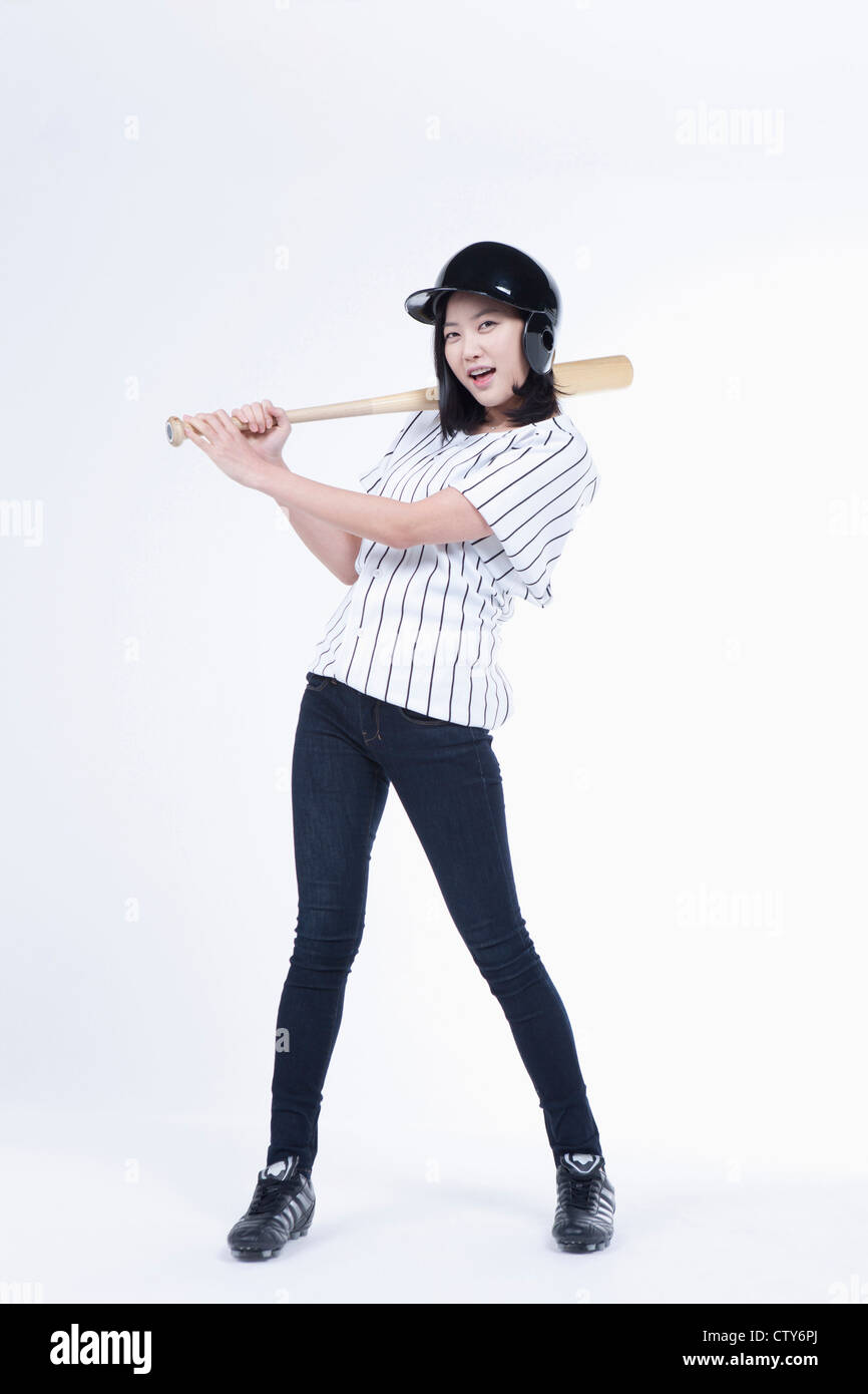 A female baseball player with a bat Stock Photo - Alamy