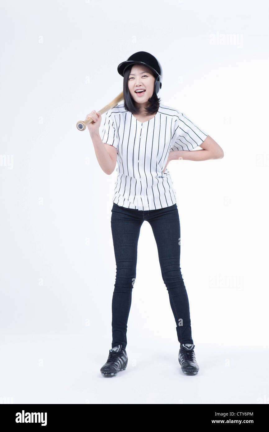 A female baseball player with a bat Stock Photo - Alamy