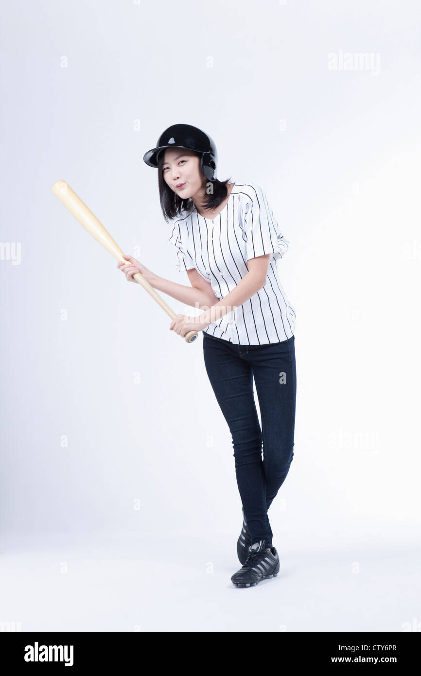 A female baseball player with a bat Stock Photo - Alamy