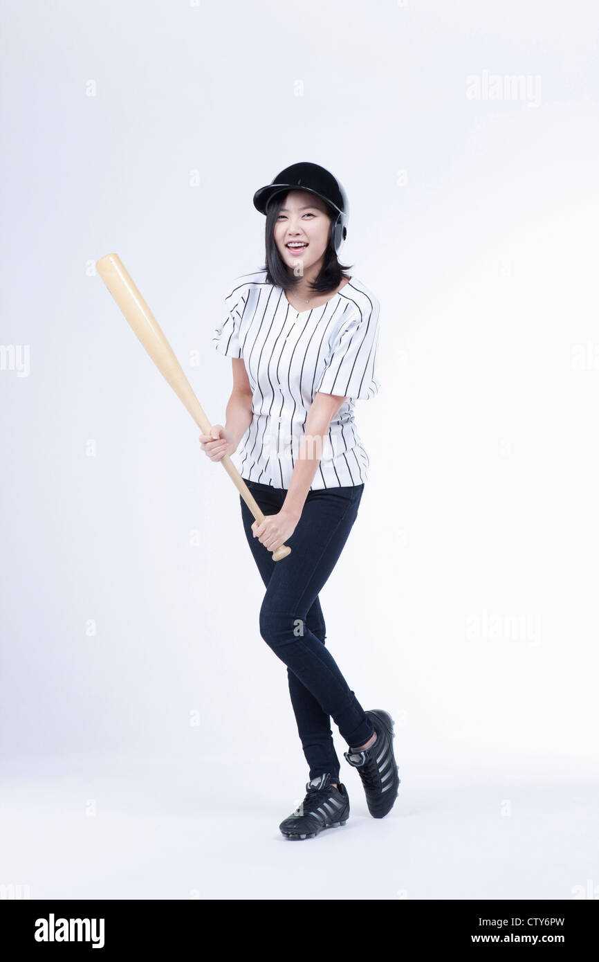 A female baseball player with a bat Stock Photo - Alamy