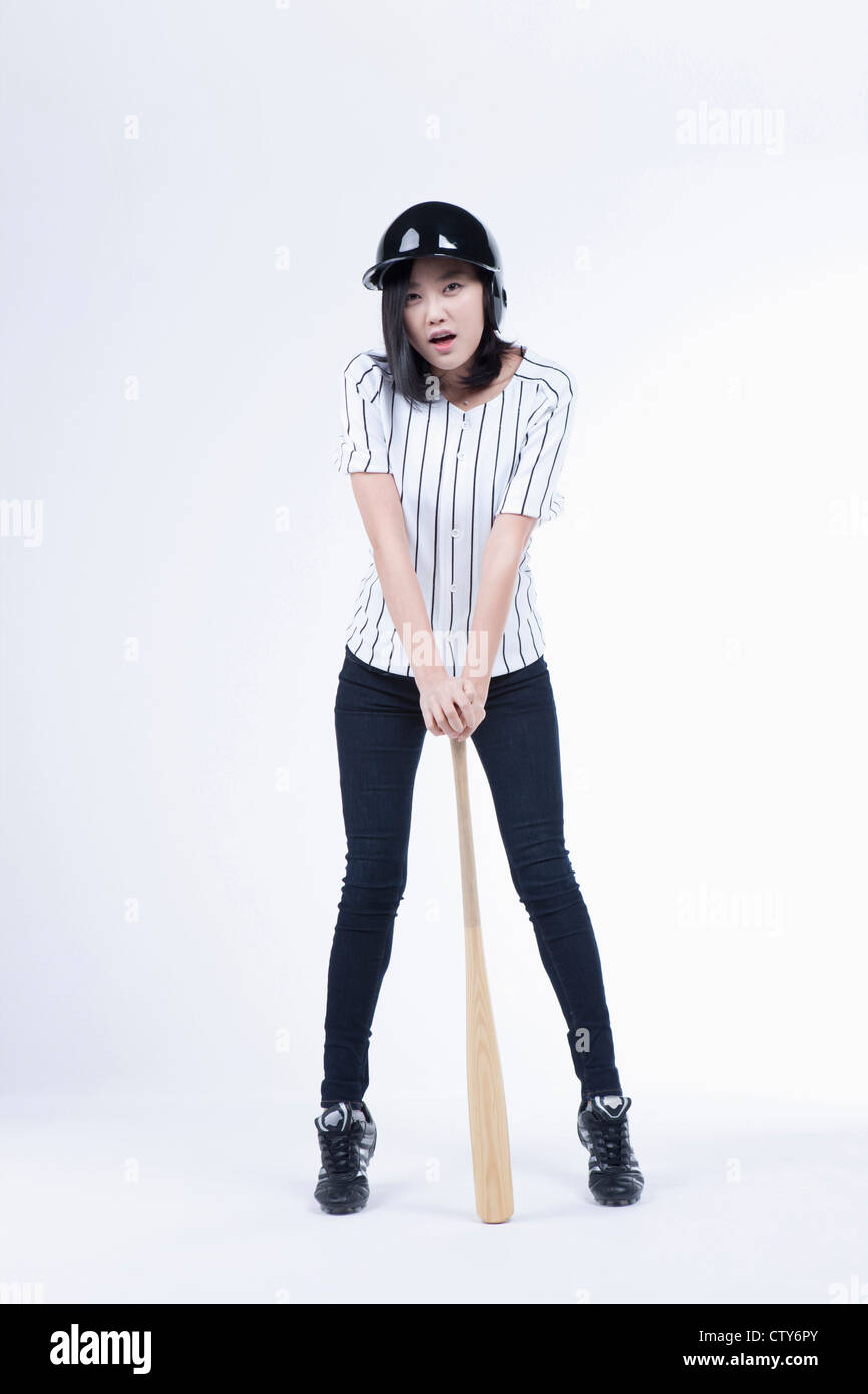 A female baseball player with a bat Stock Photo - Alamy