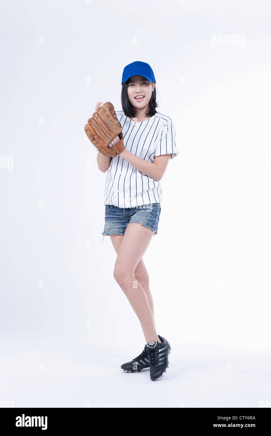 A female baseball player pitching a ball Stock Photo - Alamy