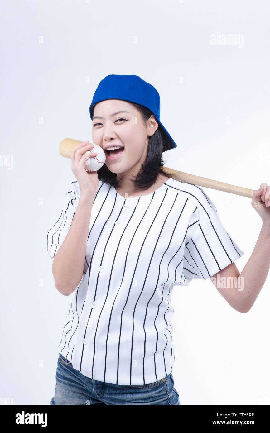 A female baseball player with a ball and bat Stock Photo - Alamy