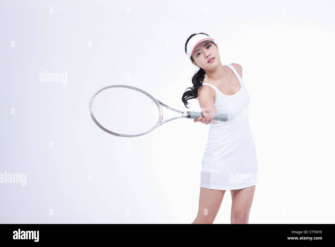 A female tennis player swing a racket Stock Photo - Alamy