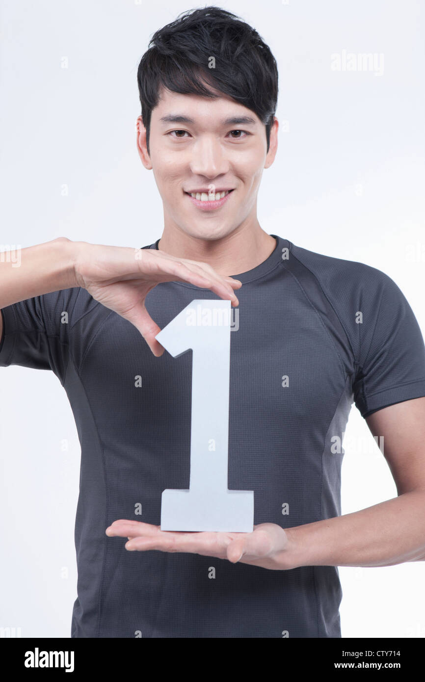 A man with the number one between his hands Stock Photo - Alamy