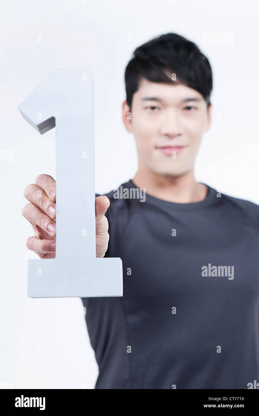 A man holding the number one Stock Photo - Alamy