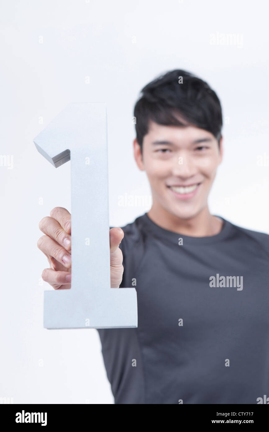 A man holding the number one Stock Photo - Alamy