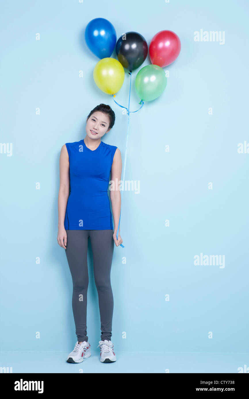 A jogging woman with colorful balloons Stock Photo - Alamy