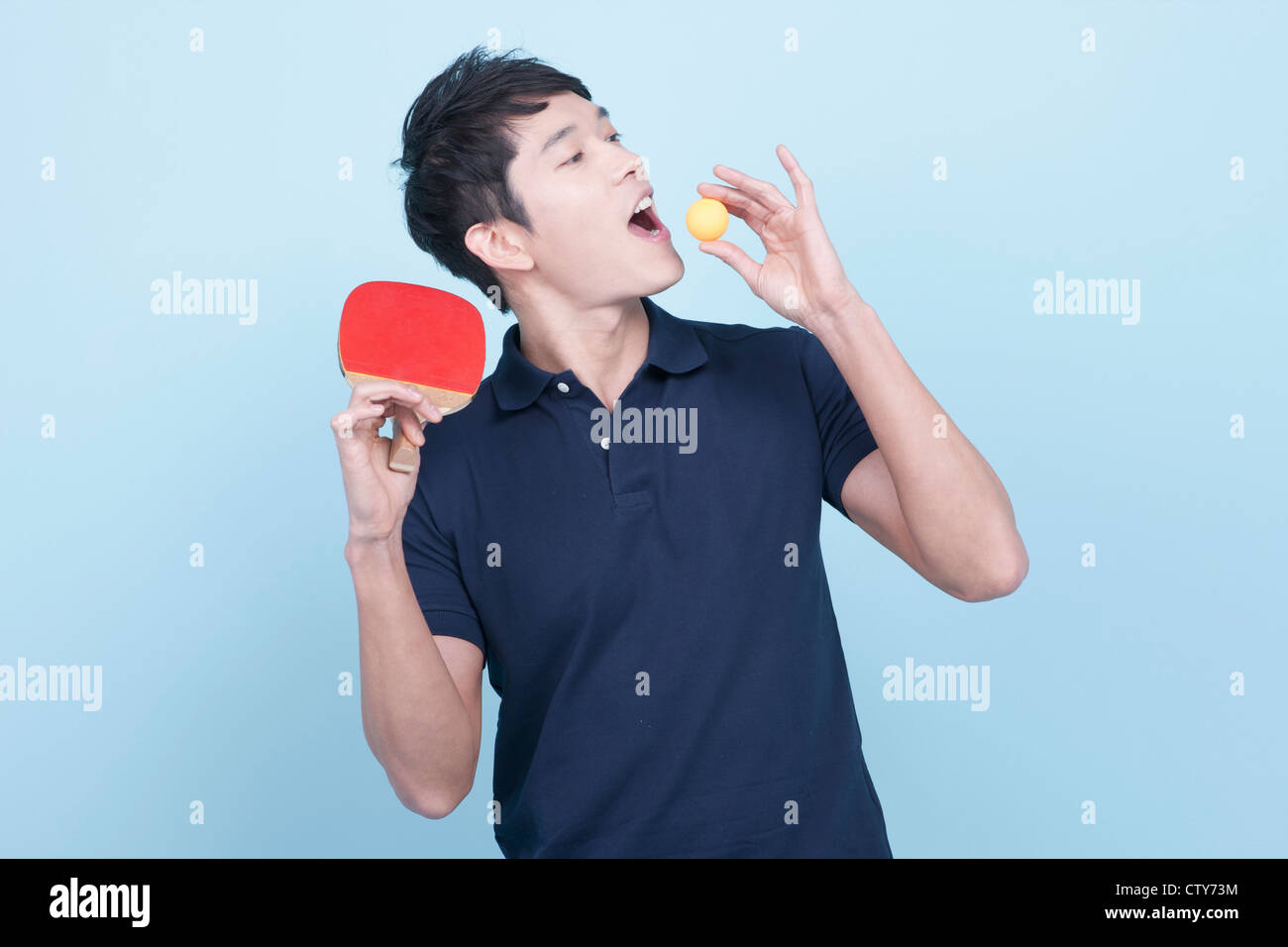 A male ping-pong player with a ball and racket Stock Photo - Alamy