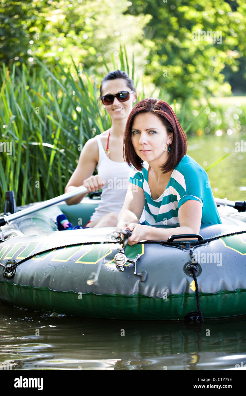 two young women on boat at summer lake Stock Photo - Alamy