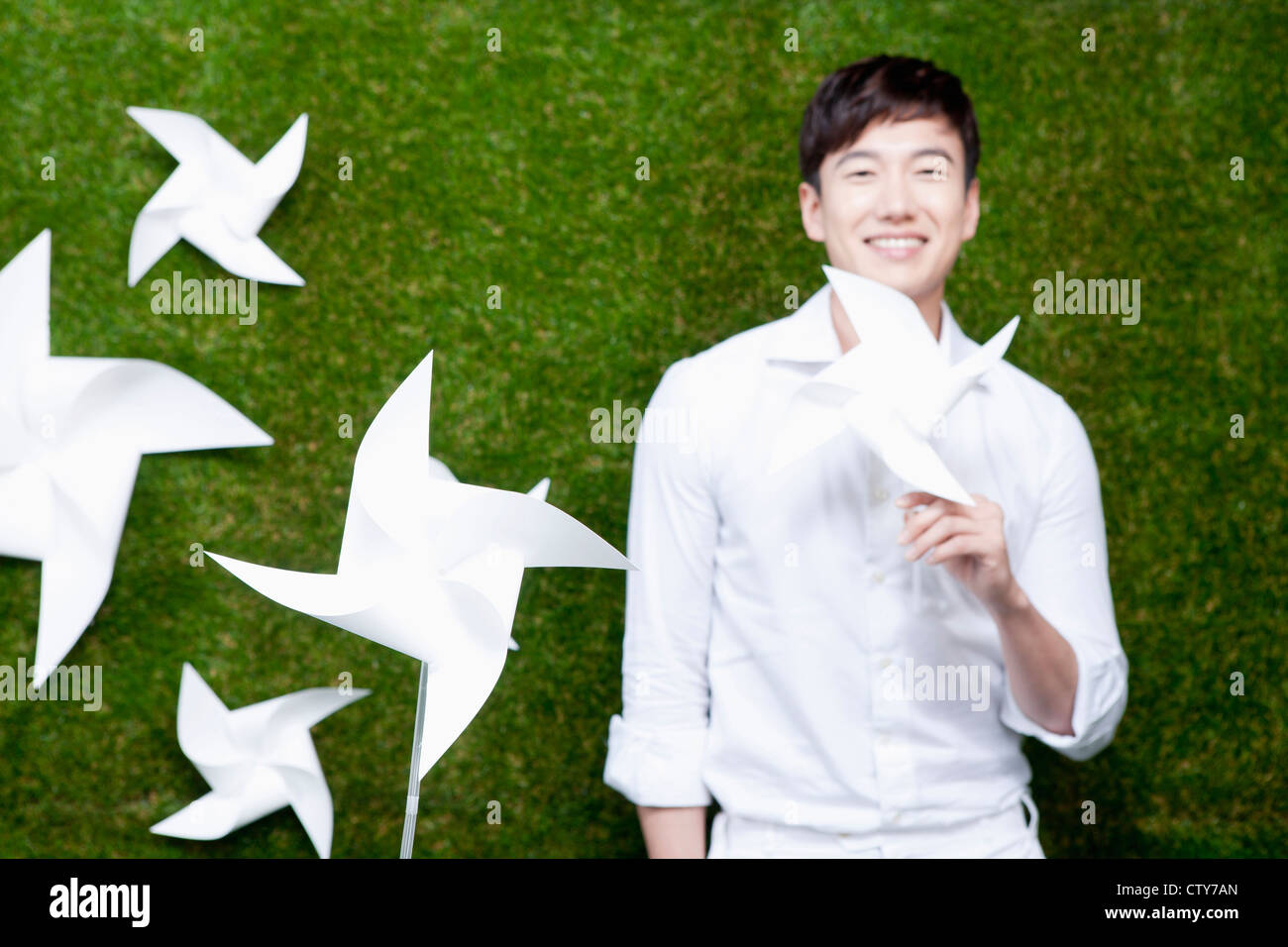 A standing man with white pinwheels Stock Photo - Alamy