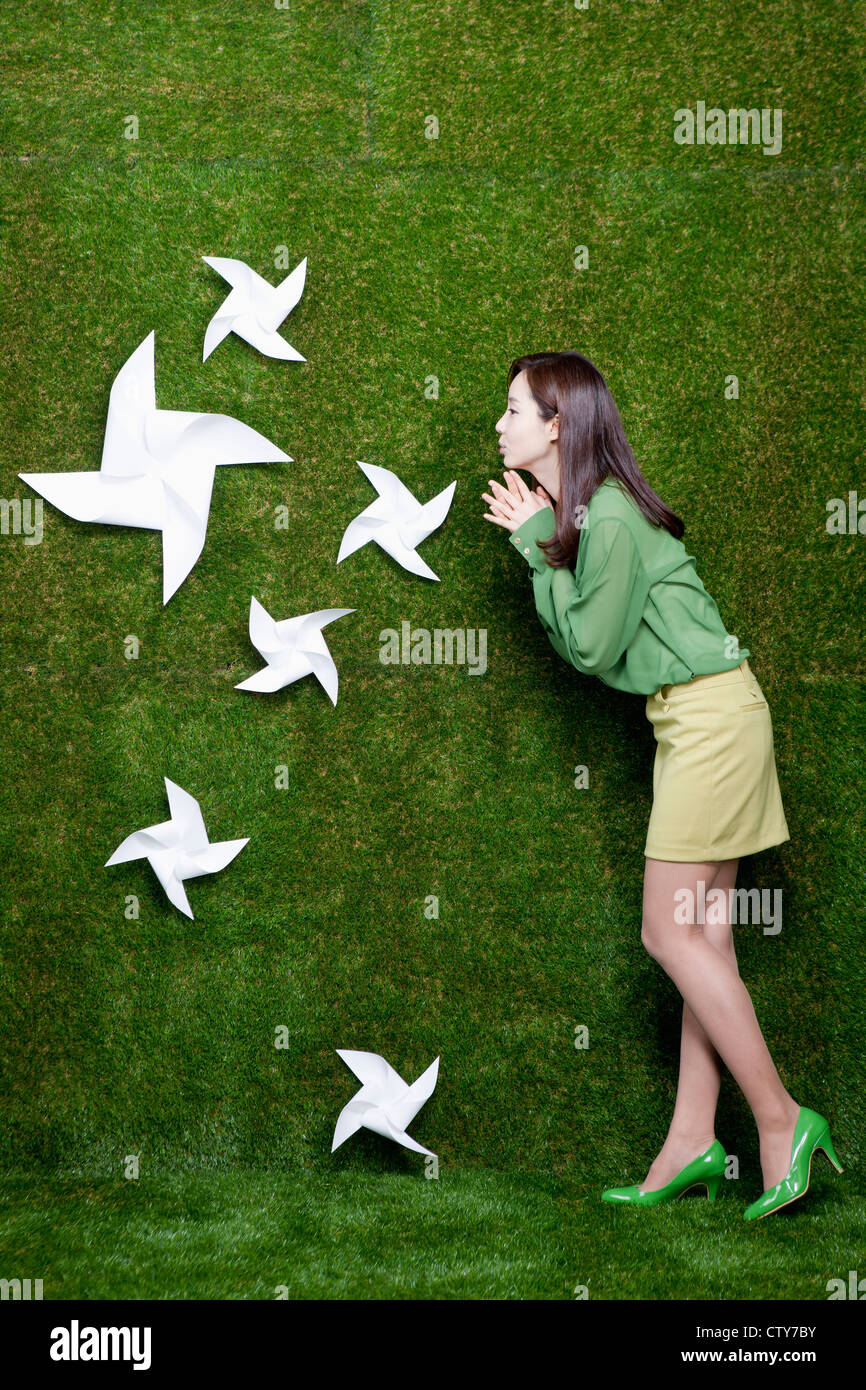 Female blowing on pinwheel hi-res stock photography and images - Alamy