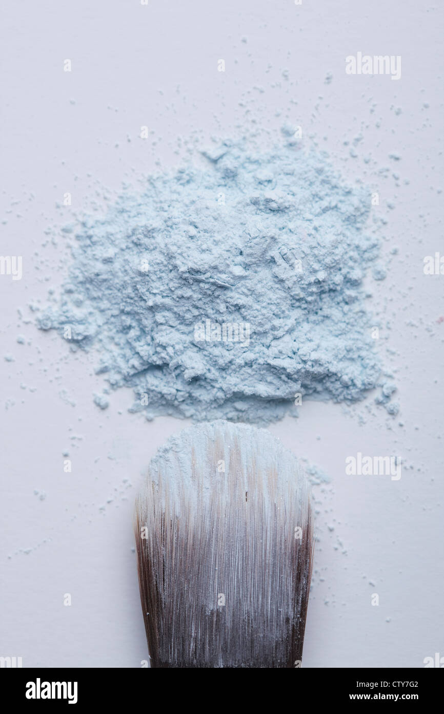 Blue powder and cosmetic brush Stock Photo - Alamy