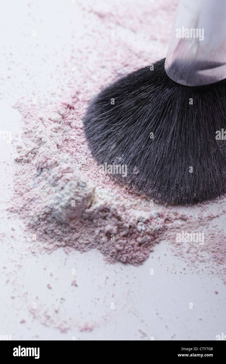 A cosmetic brush with colorful powder Stock Photo - Alamy