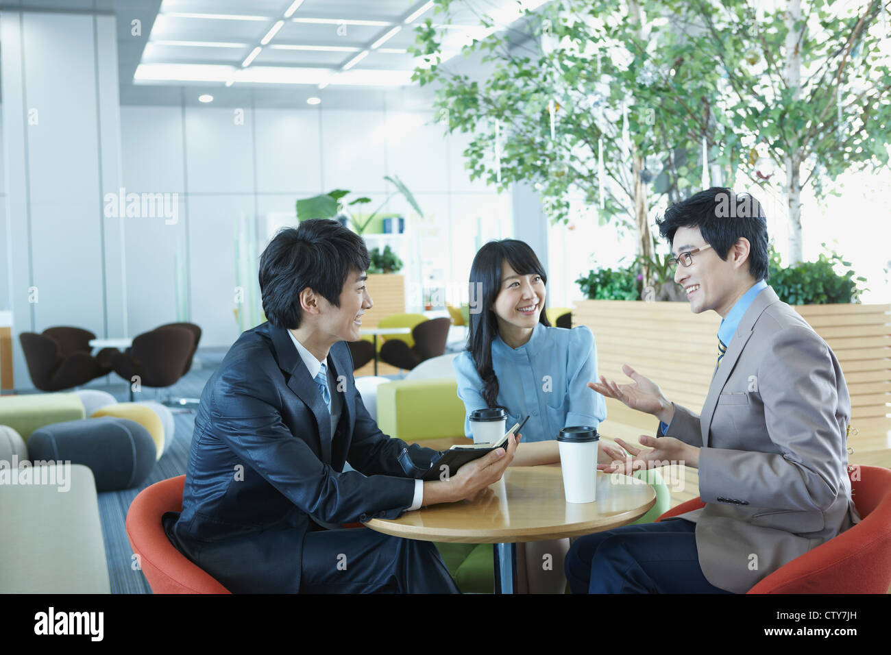 Businessmen having a talk in the lounge Stock Photo - Alamy