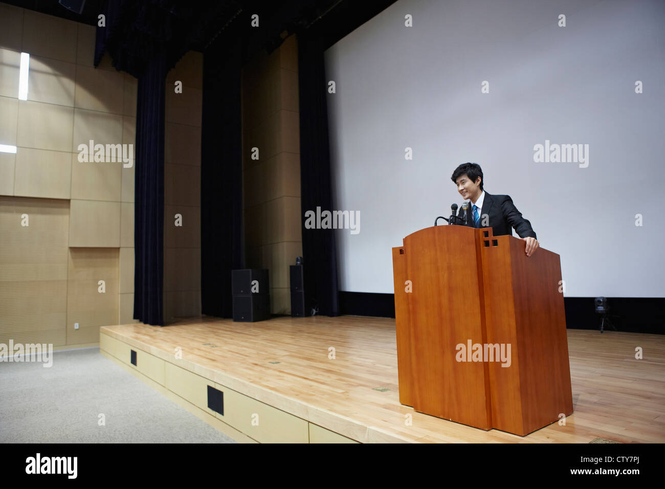 A businessman having presentation on the stage Stock Photo - Alamy