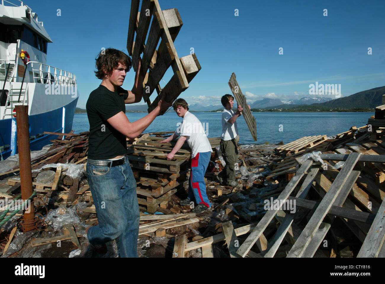Midsummer Eve bonfire being built out of wooden pallets and crates at ...