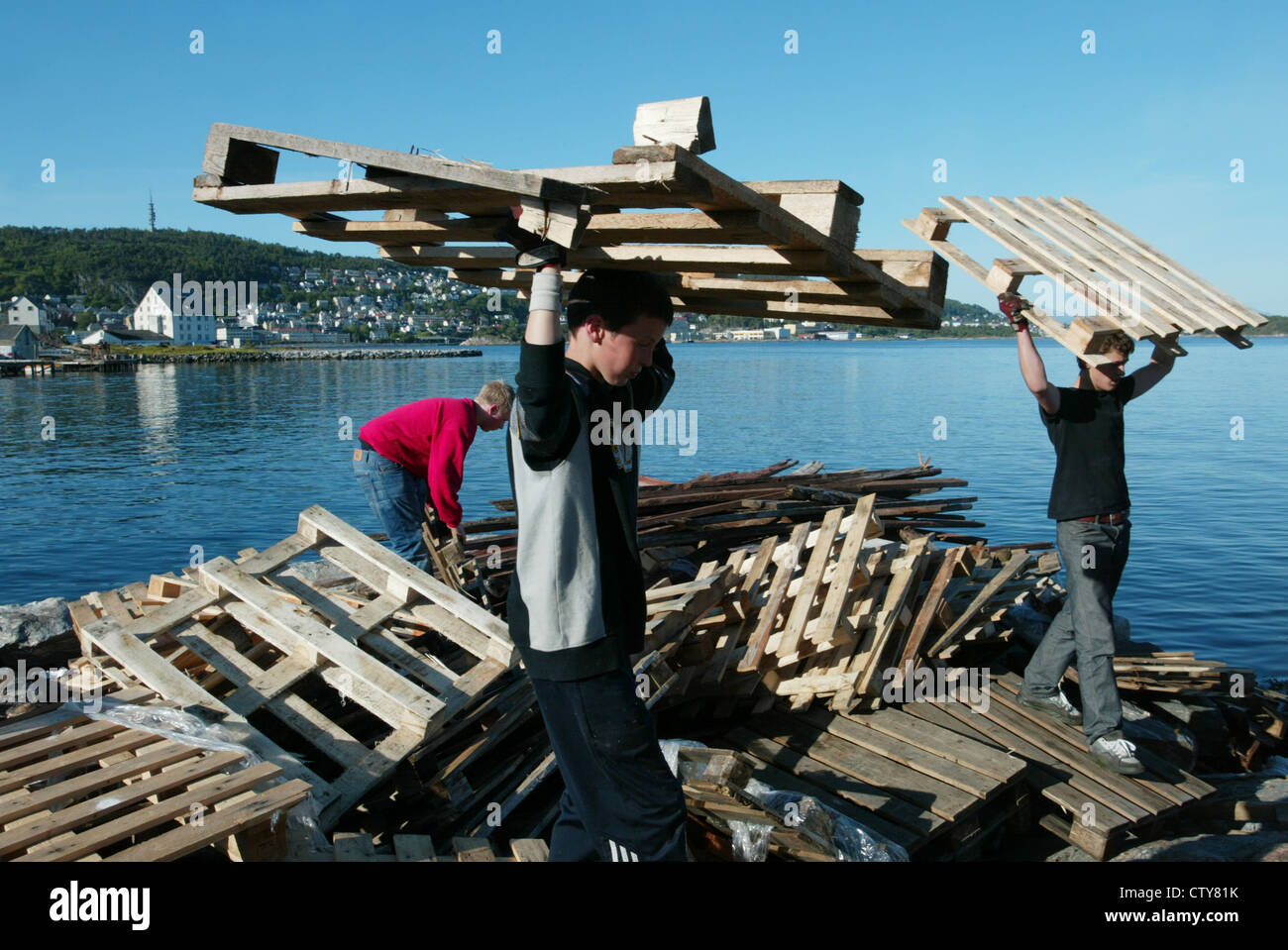 Midsummer Eve bonfire being built out of wooden pallets and crates at ...