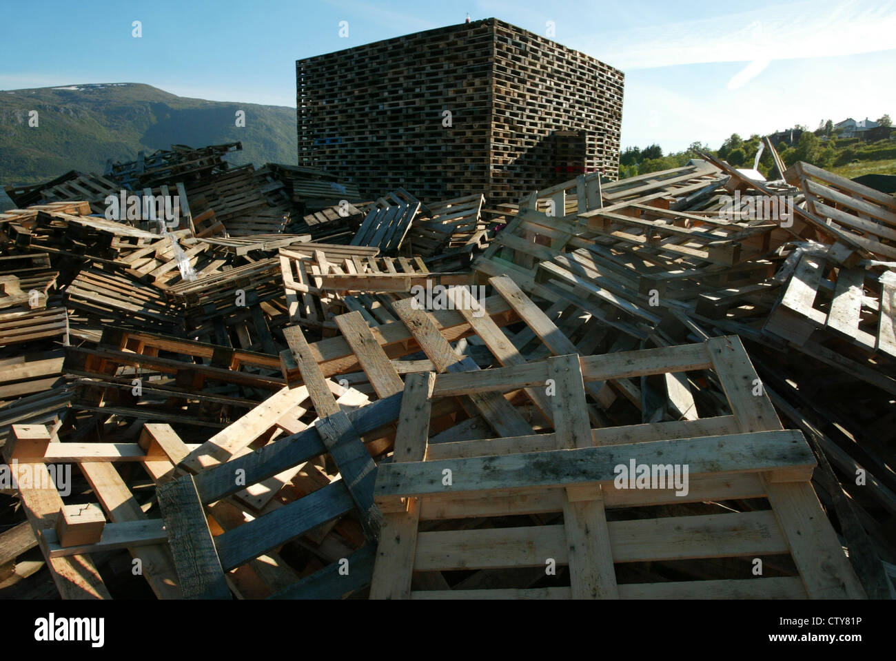 Midsummer Eve bonfire being built out of wooden pallets and crates at ...