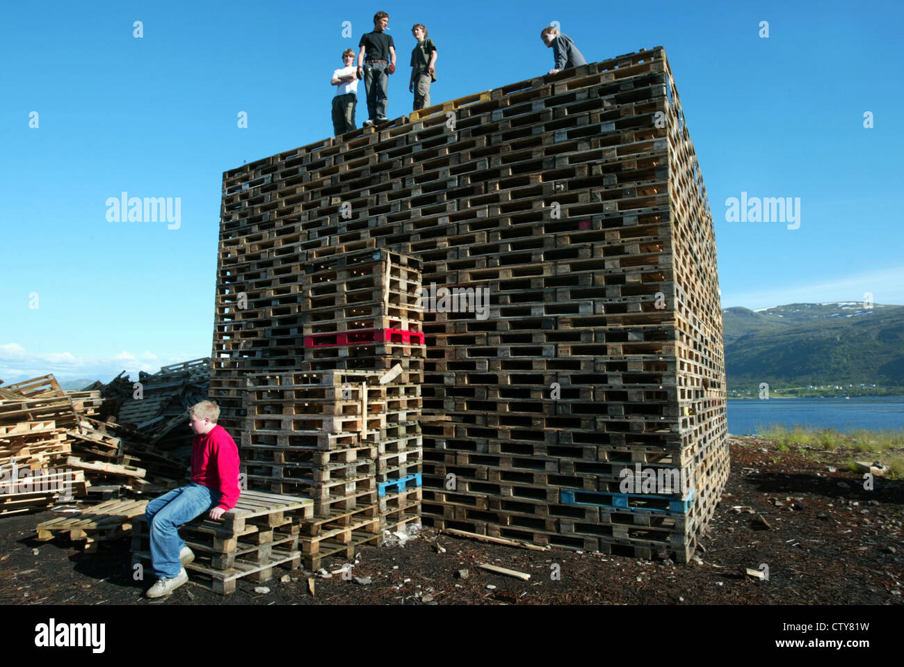 Midsummer Eve bonfire being built out of wooden pallets and crates at ...