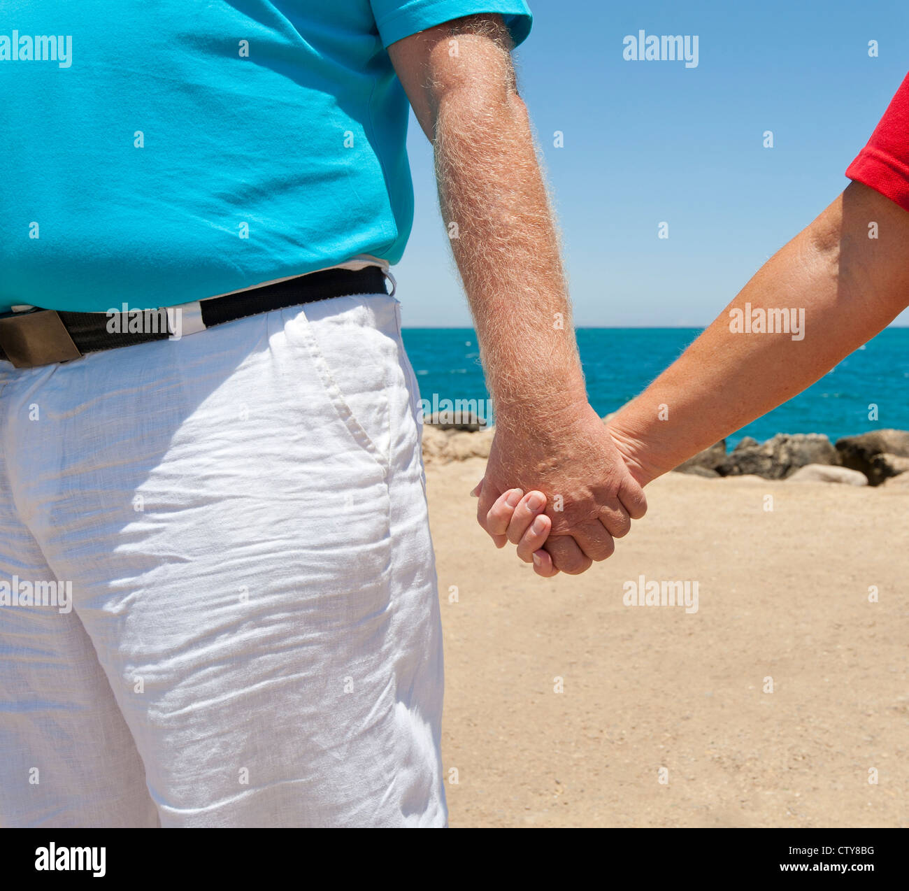 Closeup of a couple holding hands on a tropical beach Stock Photo - Alamy