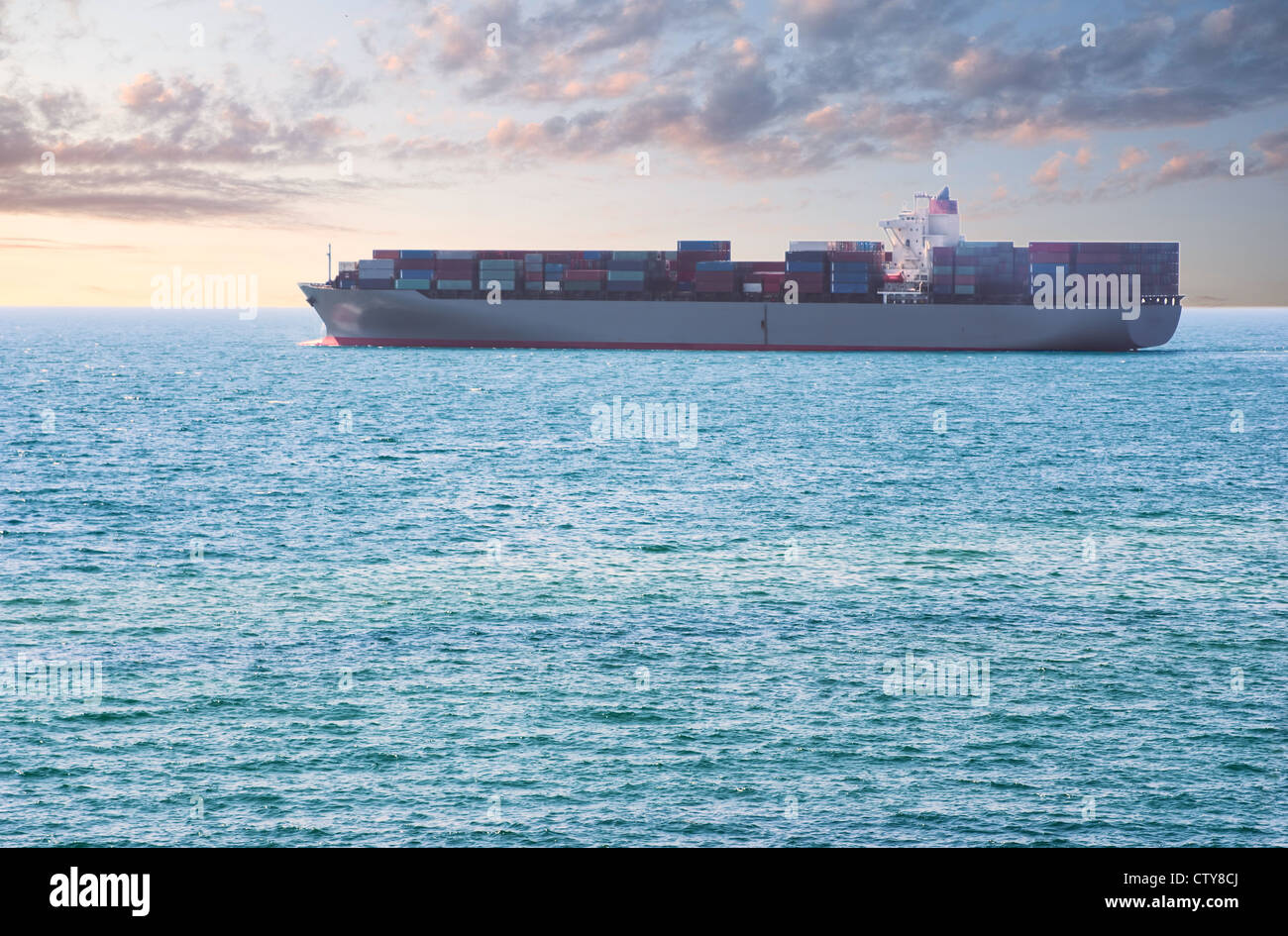 Container ship into the sunset Stock Photo - Alamy