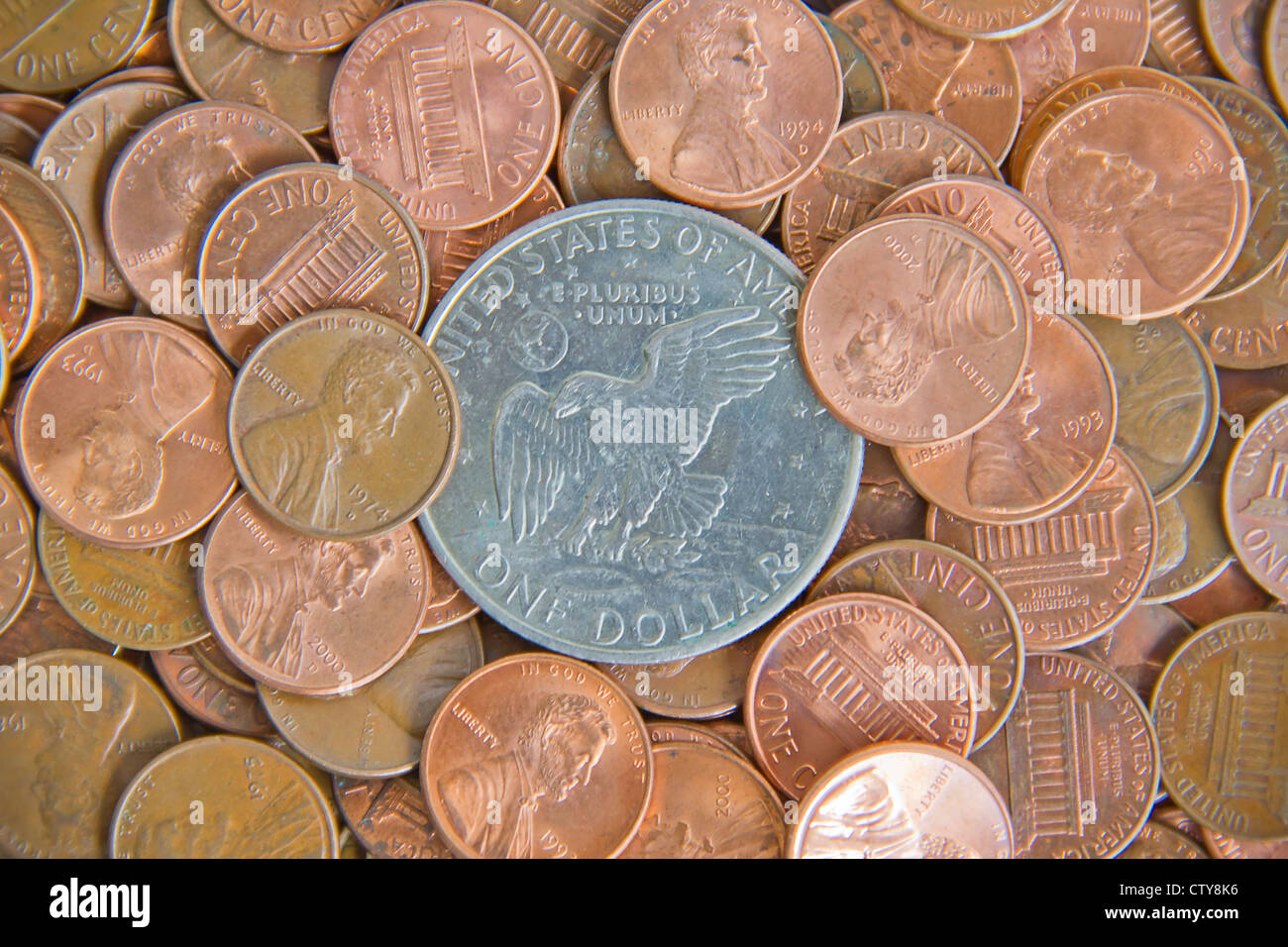 Pile of US coins with dollar on top Stock Photo - Alamy
