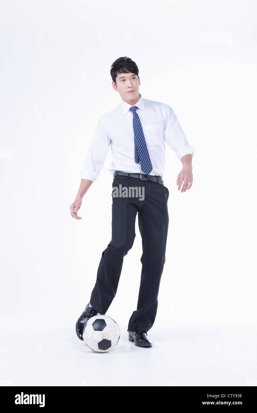 A man kicking a soccer ball Stock Photo - Alamy
