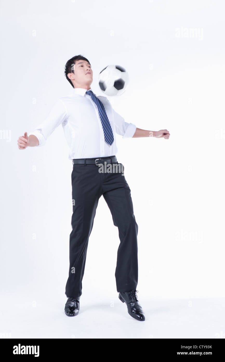 A man getting a soccer ball with his chest Stock Photo - Alamy