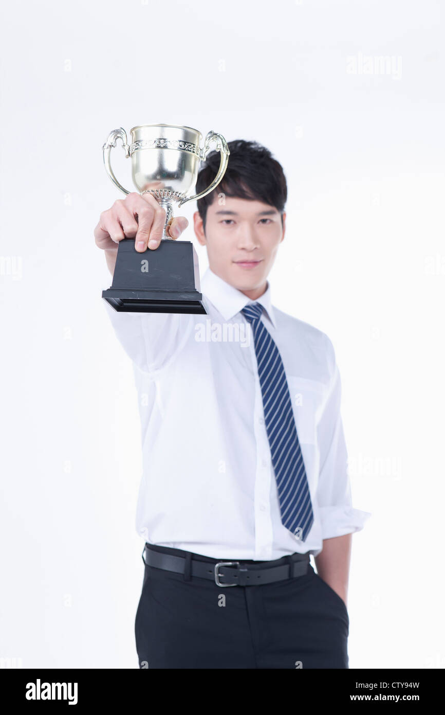 A man holding a trophy Stock Photo - Alamy
