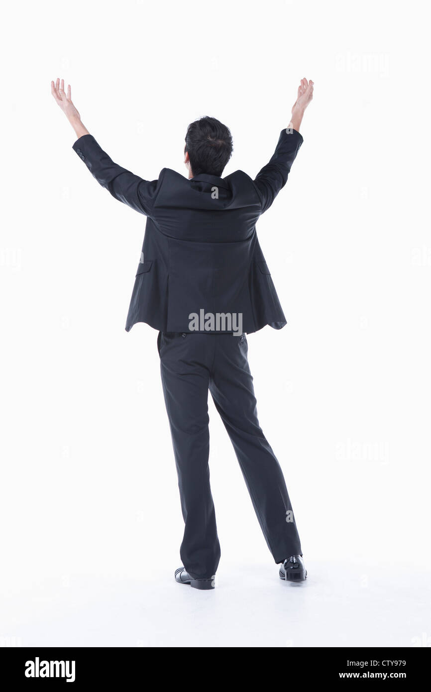 A man putting his arms up to the sky Stock Photo - Alamy