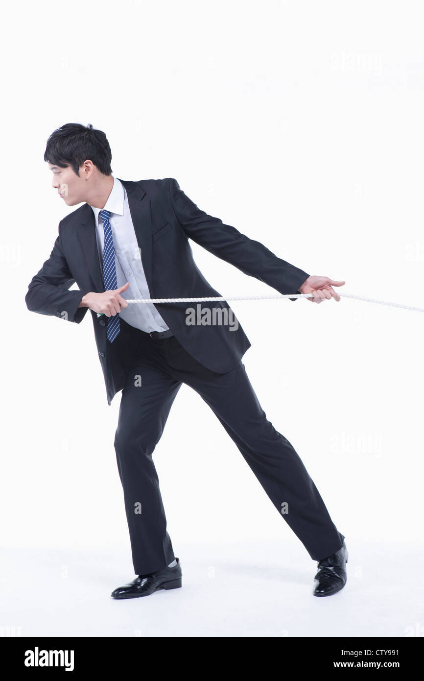 A man pulling a rope Stock Photo - Alamy