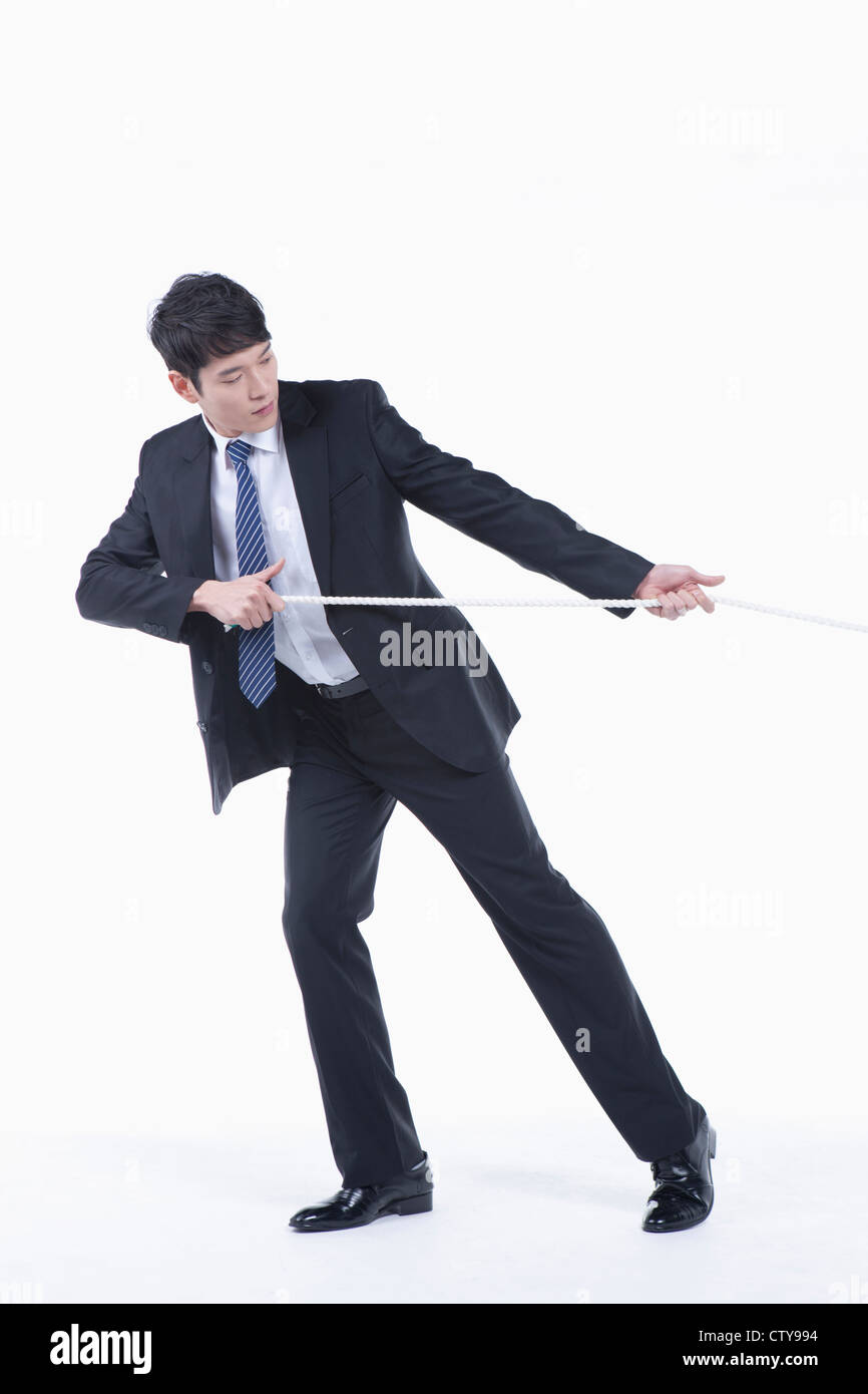 A man pulling a rope Stock Photo - Alamy