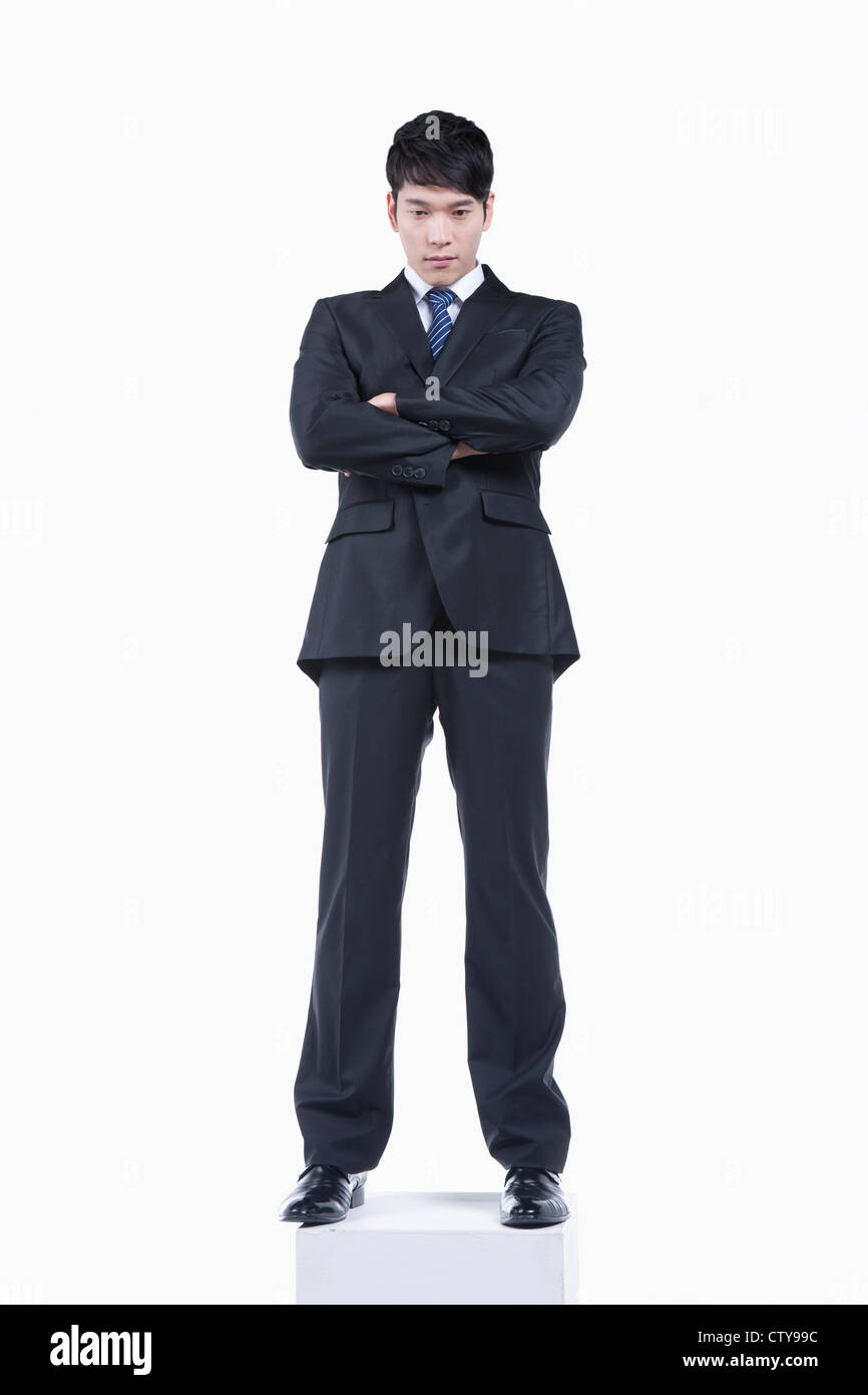 A man standing with his arms crossed Stock Photo - Alamy