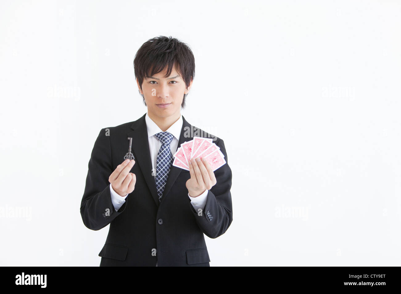 Businessman holding cards and key Stock Photo - Alamy