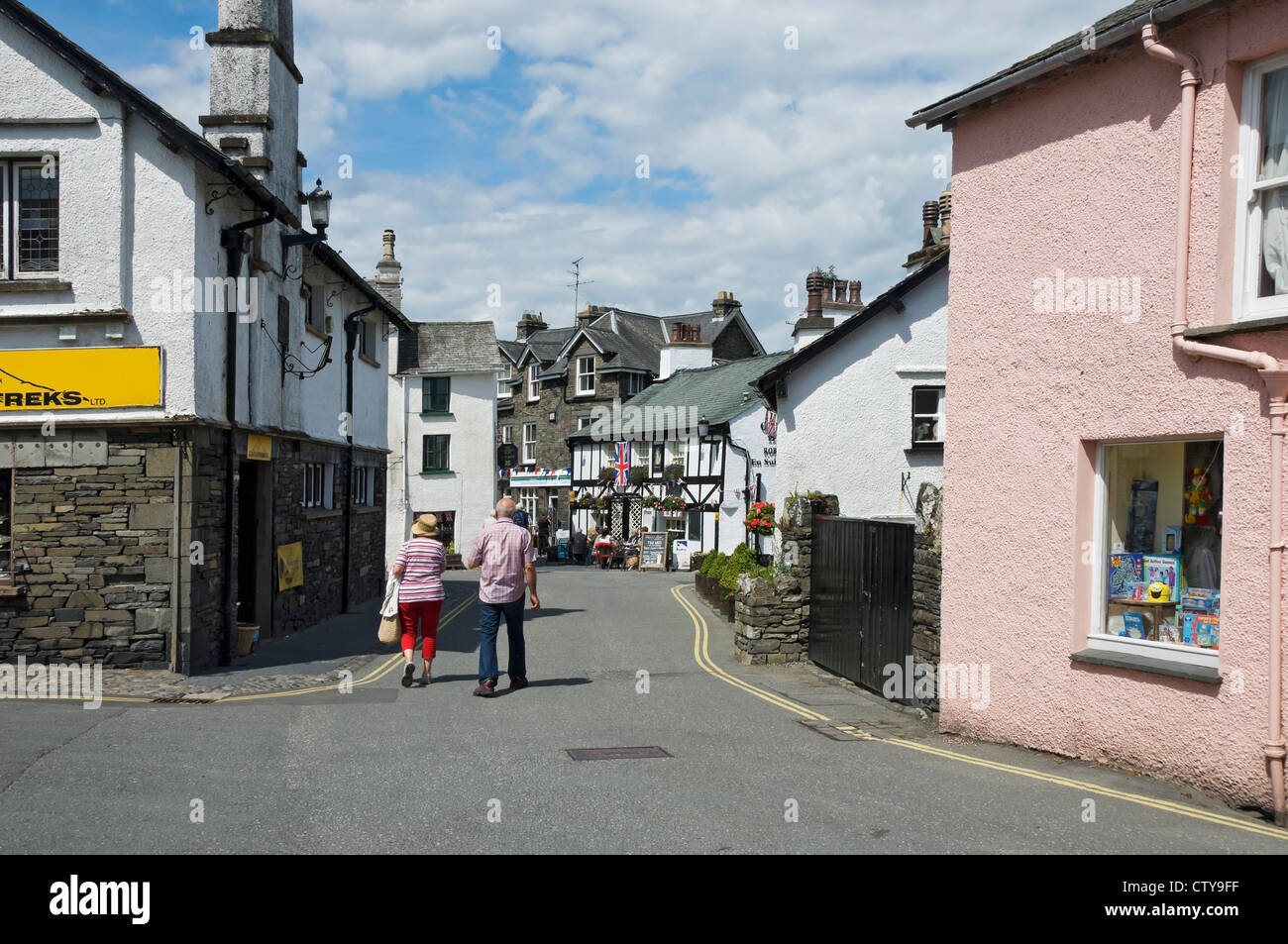 People visitors tourists walking around Hawkshead village in summer ...
