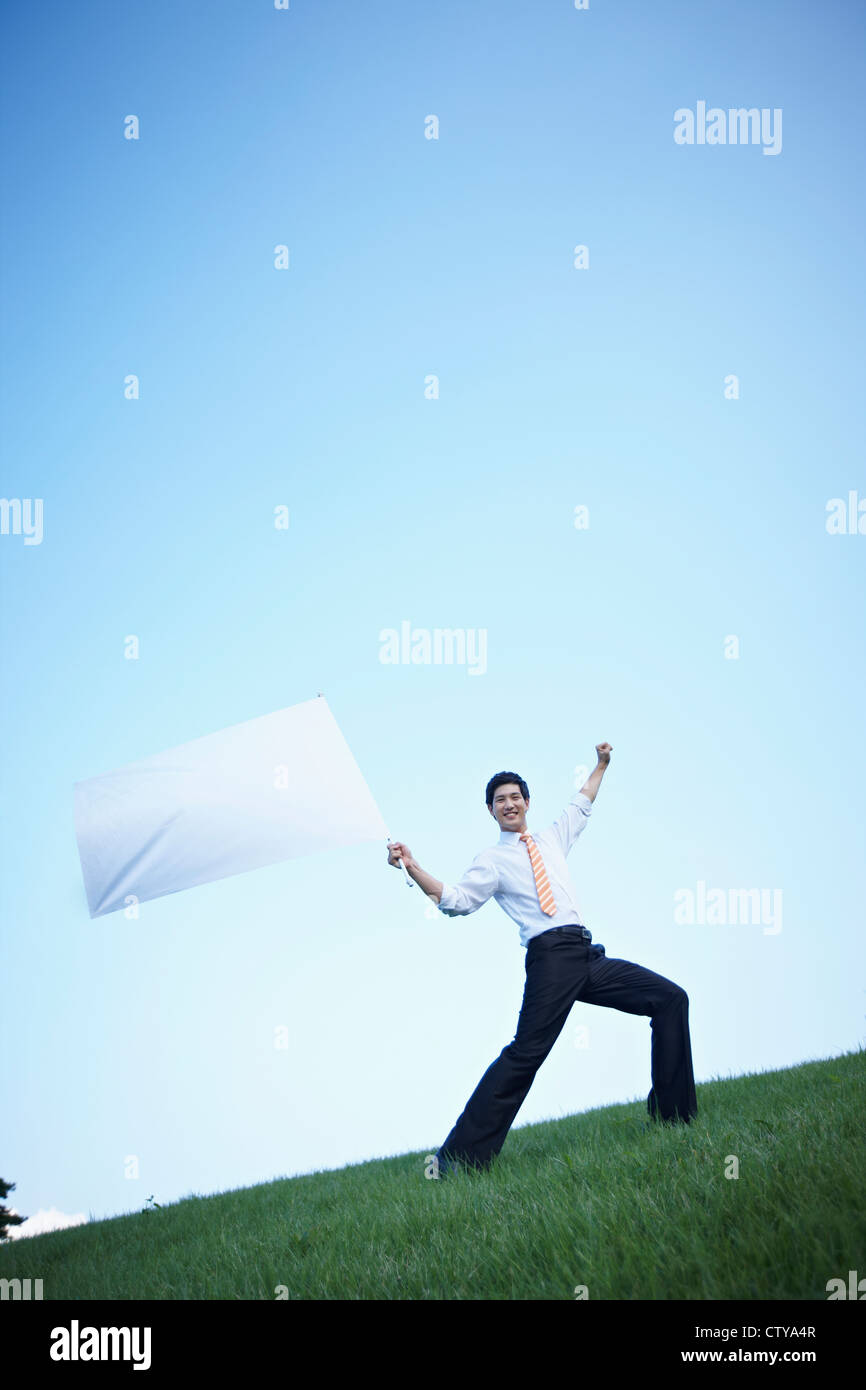 A businessman holding the white flag Stock Photo - Alamy