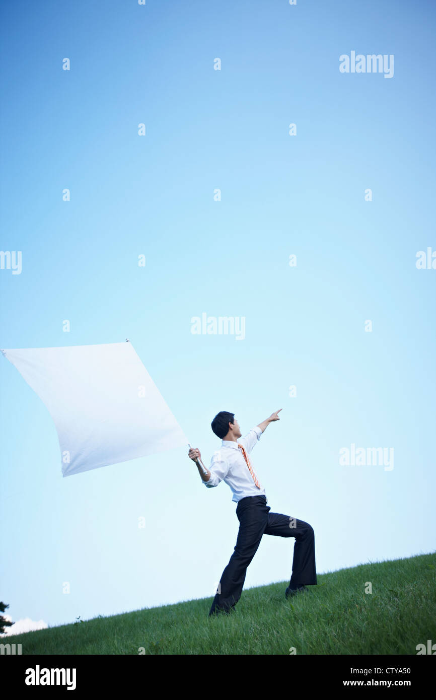 A businessman holding the white flag Stock Photo - Alamy