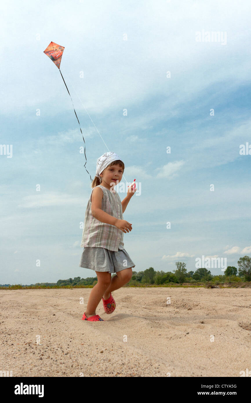 Girl flying a kite Stock Photo - Alamy