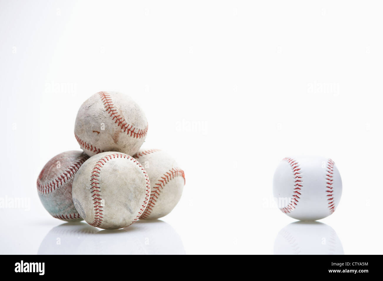 Worn out baseballs and a clean baseball Stock Photo - Alamy