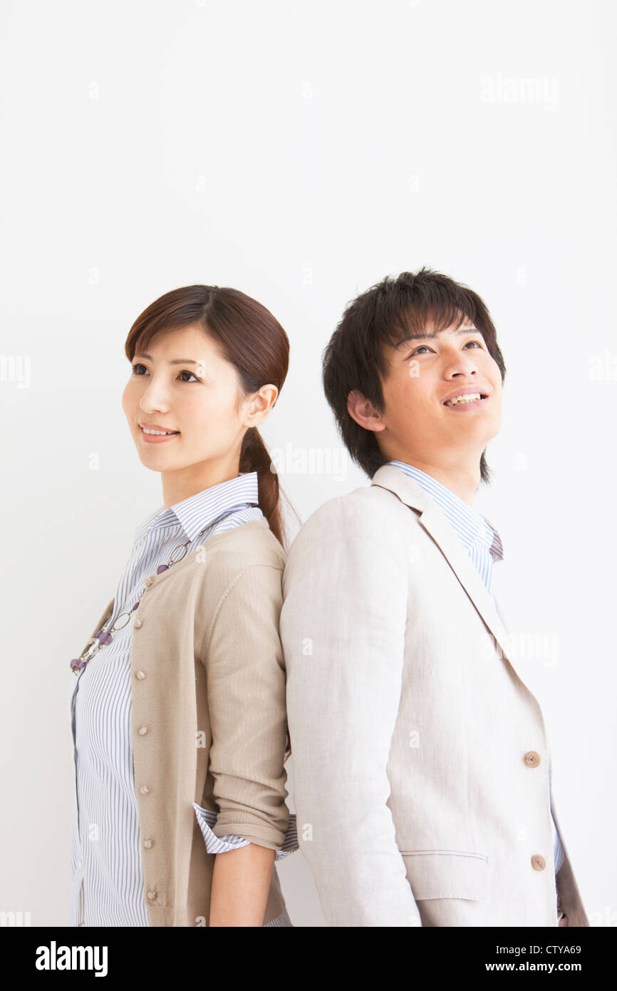 Businesspeople standing back to back Stock Photo - Alamy