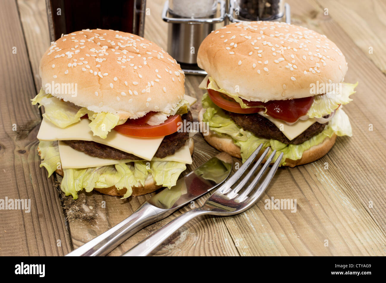 Two Cheeseburger (one double Cheeseburger) on wooden background Stock ...