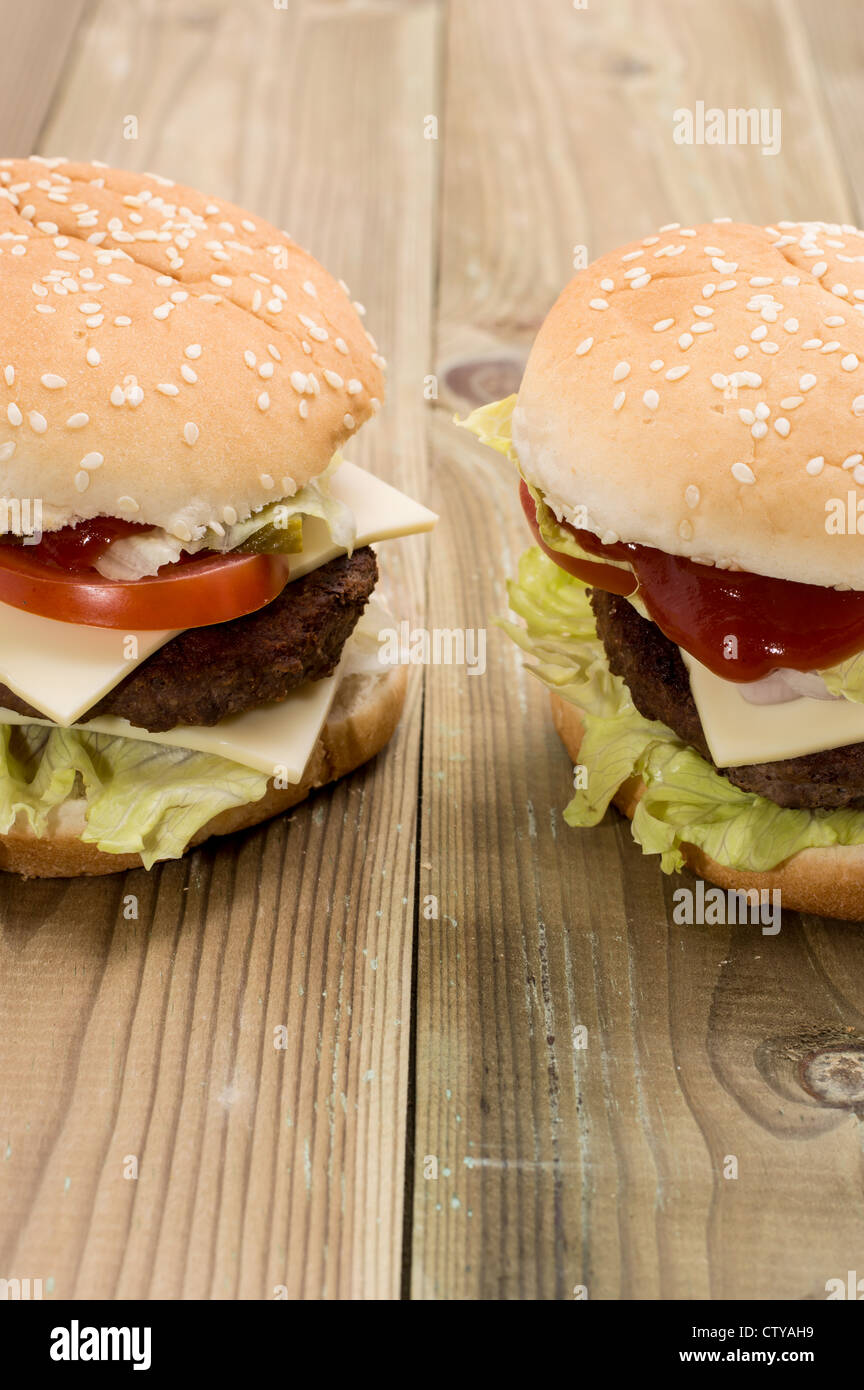 Two Cheeseburger (one double Cheeseburger) on wooden background Stock ...