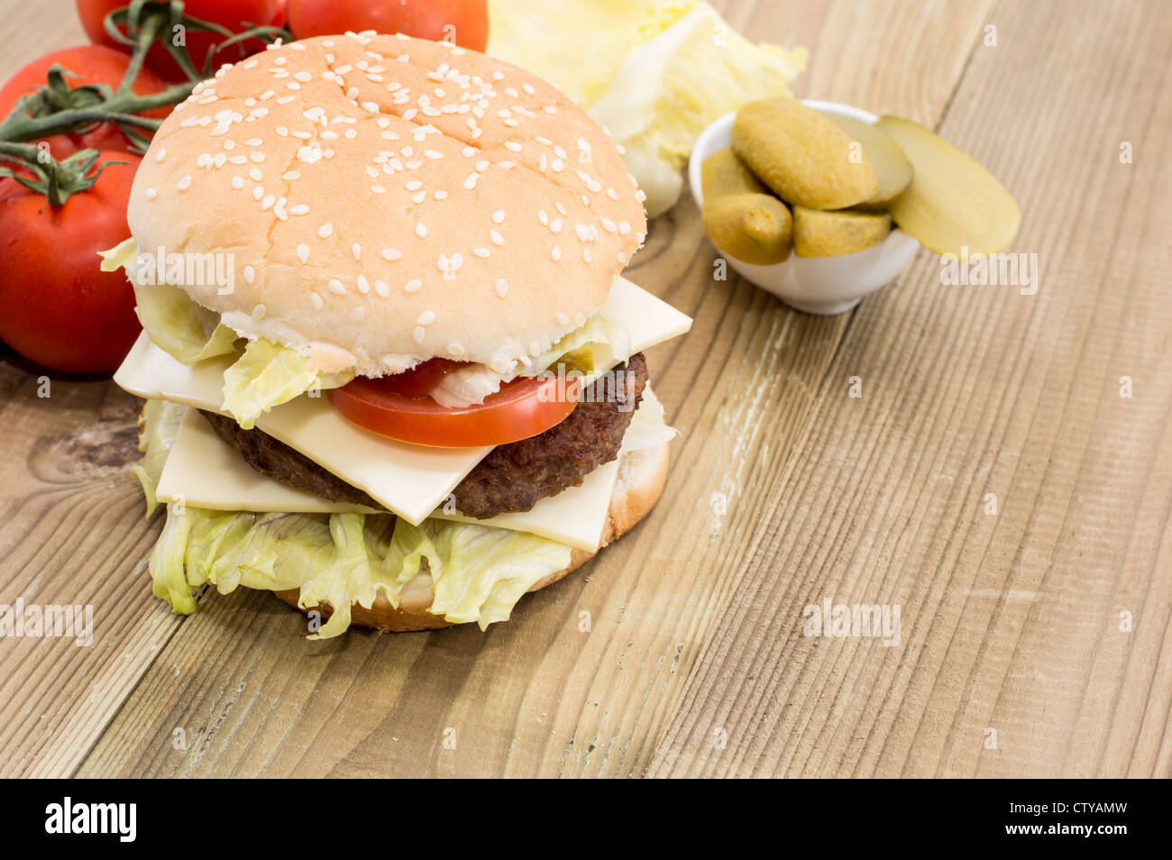 Double Cheeseburger with ingredients on a old wooden table Stock Photo ...
