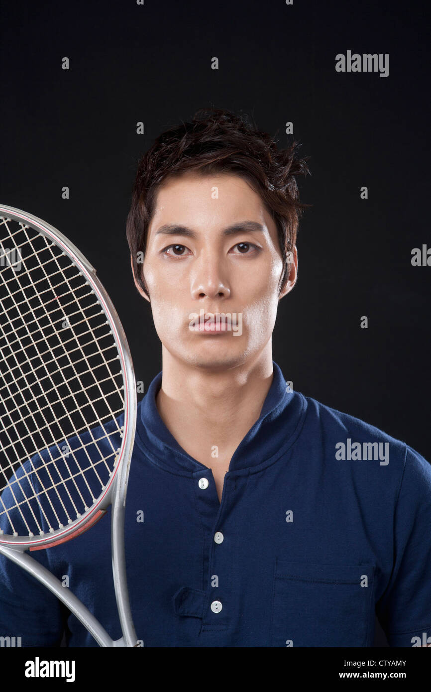A man with a tennis racket Stock Photo - Alamy