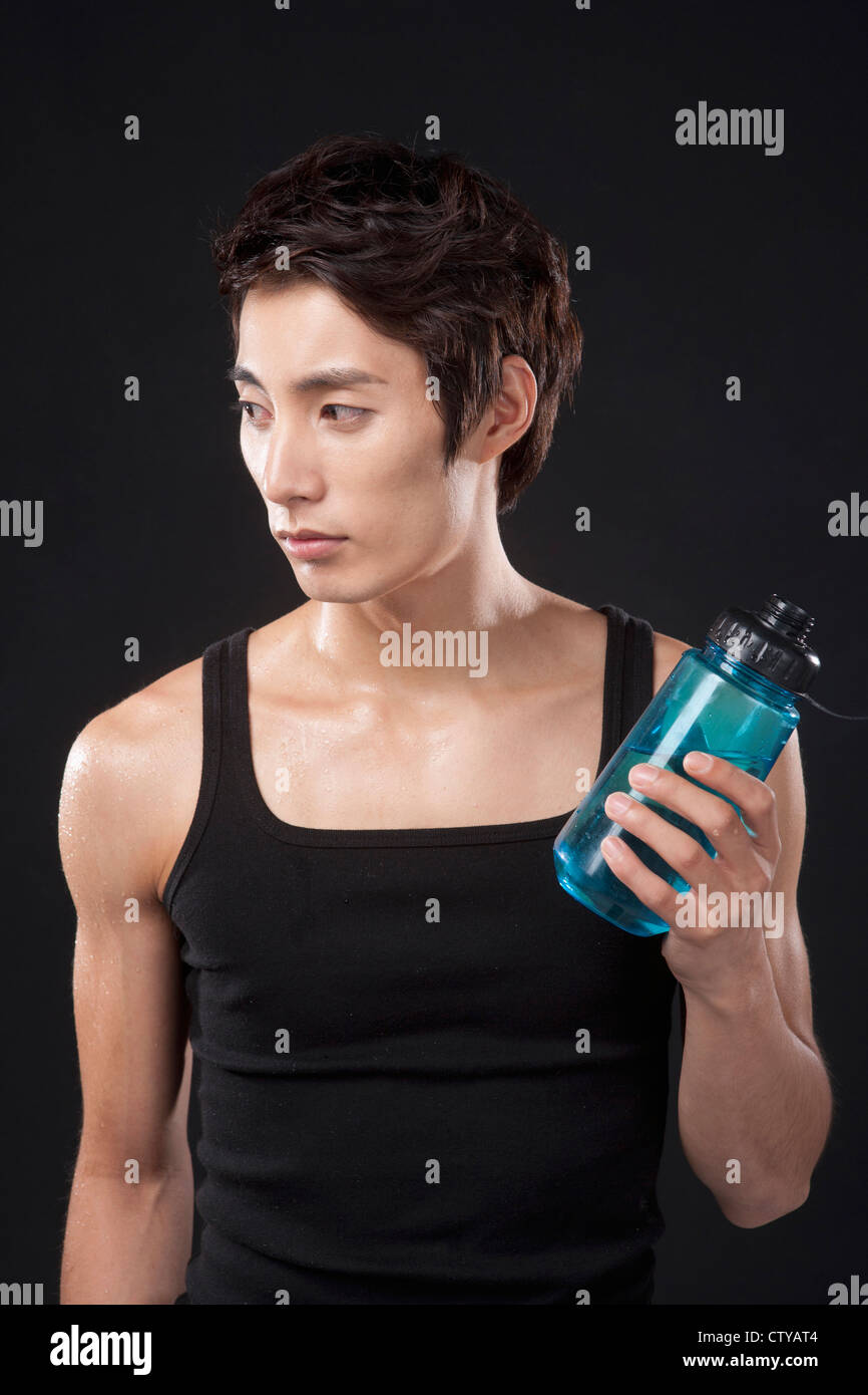 A man holding the bottle of water Stock Photo - Alamy