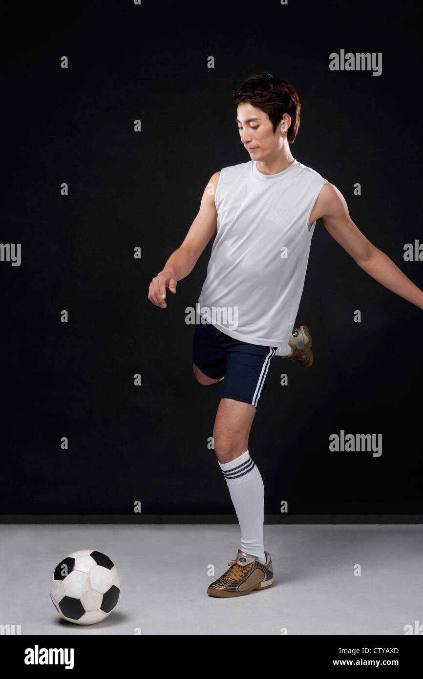 A man playing soccer Stock Photo - Alamy