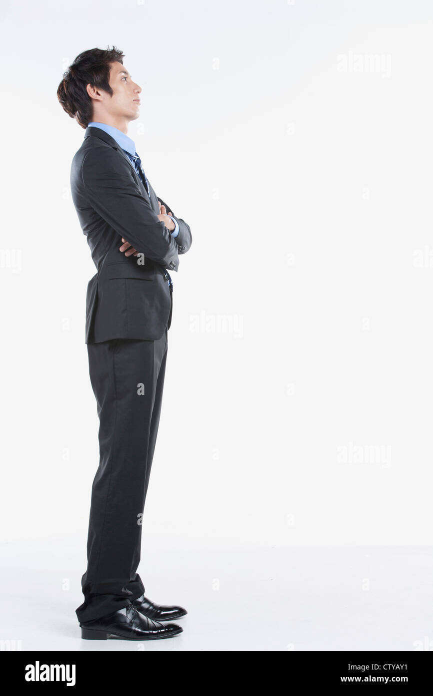 A man standing with his arms crossed Stock Photo - Alamy