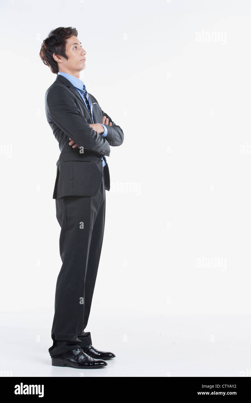 A man standing with his arms crossed Stock Photo - Alamy
